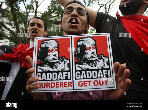 A Libyan Living In Malaysia Holds A Picture Of Libyan Leader Moammar