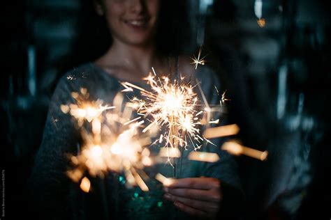 Woman Holding Sparklers Several Of Them Creating Heart Shaped Blur