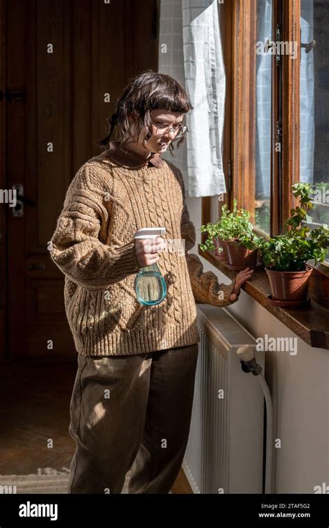 Caring Teen Girl Spraying Water Watering Potted Houseplant Enjoying