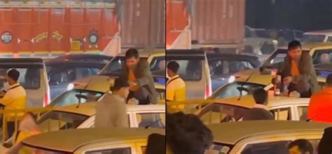 Video Man Drinks Alcohol On Cars Roof