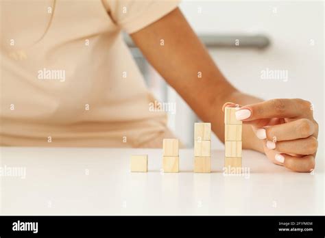 Woman Hand Putting And Stacking Blank Wooden Cubes On Desk With Copy Space For Input Wording And