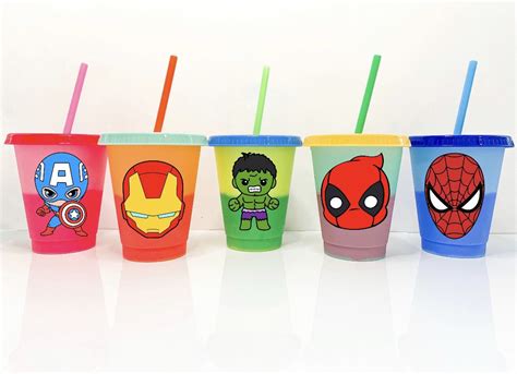 Four Different Colored Cups With Cartoon Characters On Them