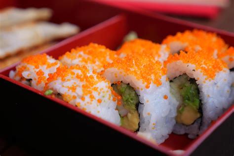 Sushi Rolls With Orange Toppings Served In A Red Box 75188791 Stock