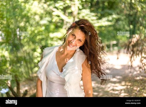 Cute Mature Woman Shakes Her Hair In A Garden Stock Photo Alamy