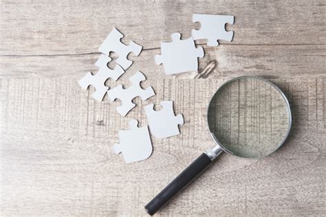 Premium Photo A Magnifying Glass And Puzzle Pieces On The Table