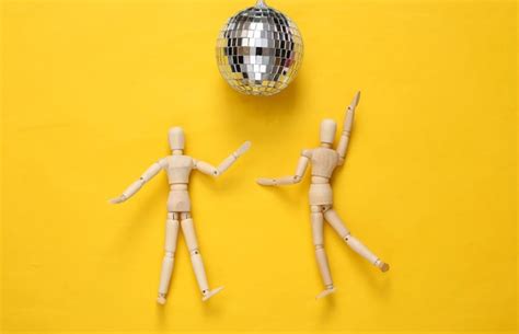 Premium Photo Two Puppets Dancing Under Disco Ball On Yellow