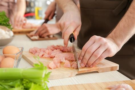 Premium Photo Man Cutting Chicken Fillet At Cooking Classes