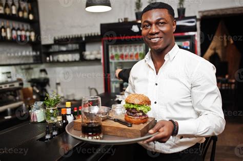 Young African American Waiter Man Hold Tray With Burger At Bar Of