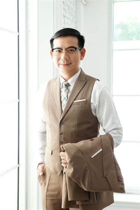 Attractive Asian Businessman In Suit And With Eyeglasses Standing Next