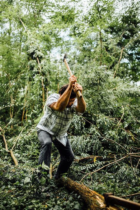 Man Chopping A Wood In The Forest By Stocksy Contributor Boris