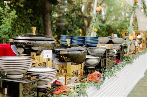 Outdoor Buffet Featuring A Variety Of Vibrant Colored Dishes Set Up At An Outdoor Event Venue