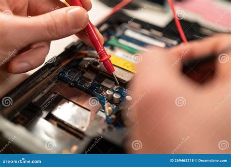 Close Up Of Male Hands Testing Laptop Motherboard Using Multimeter Stock Photo Image Of Cable