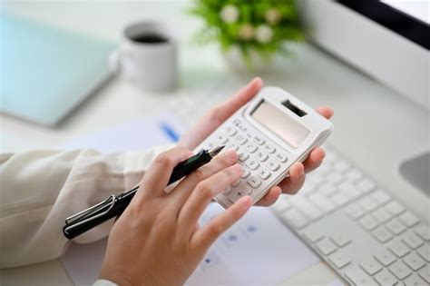 Premium Photo A Female Accountant Using Calculator Calculating Sales And Profit Working At Her