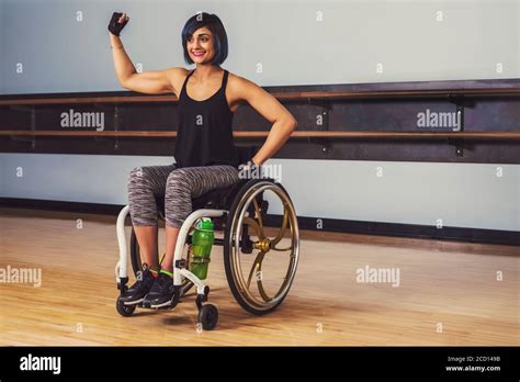 A Paraplegic Woman Taking A Break In A Gymnasium After Working Out In A