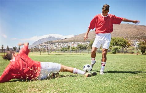 Men Soccer And Slide Tackle In Sports Fitness Training And Exercise