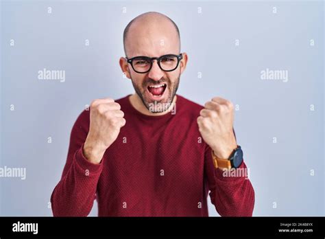 Young Bald Man With Beard Standing Over White Background Wearing