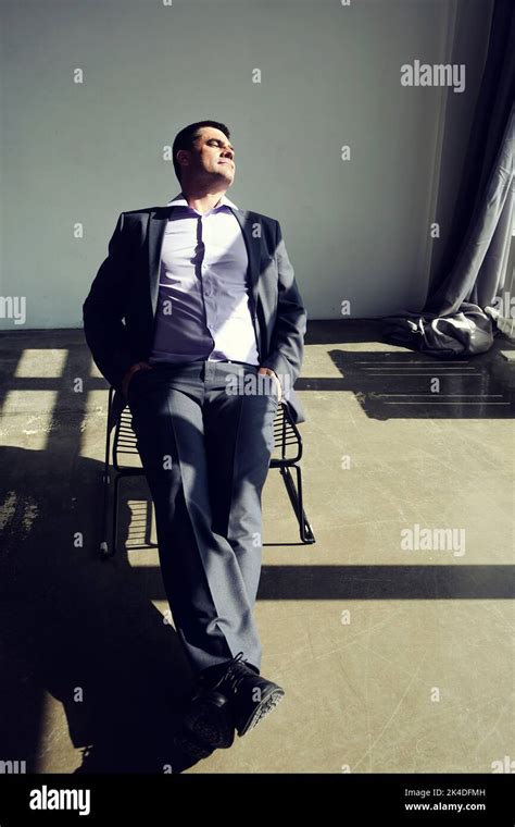 Man Resting In An Armchair With His Legs Stretched Out Is Dreaming With