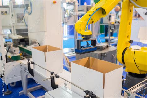 Automatic Sorting Conveyor System Yellow Robotic Arm Manipulator Working With Cardboard Boxes