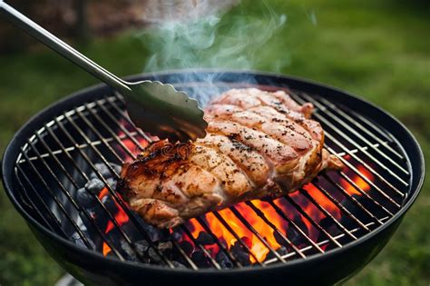 Grilling Fresh Pork On Charcoal Grill With Steel Tongs Stock