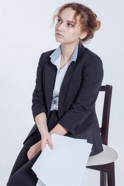 Premium Photo Young Office Worker Girl In Classic Suit Keeps Clean