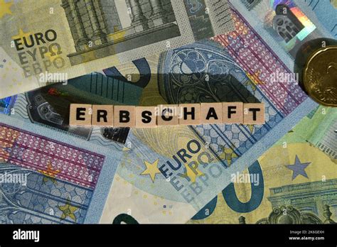The German Word For Heritage With Wodden Cubes And Euro Bills Stock