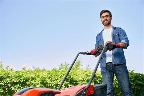Premium Photo Smiling Male Gardener In Protective Glasses Trimming
