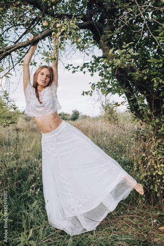 Playful Model In White Posing Under Tree Blush Fashion Model