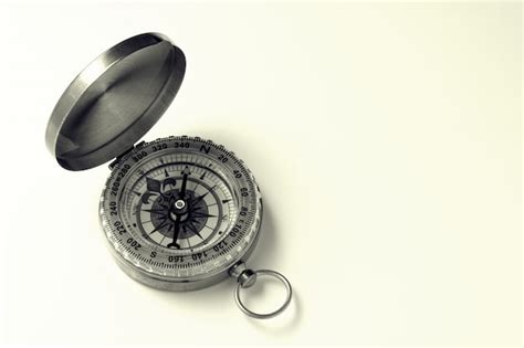 Premium Photo Compass On Brown Paper Background