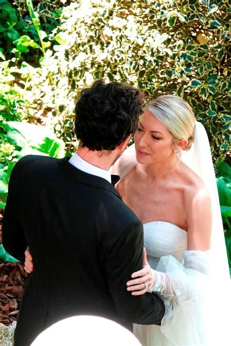 A Bride And Groom Standing Next To Each Other