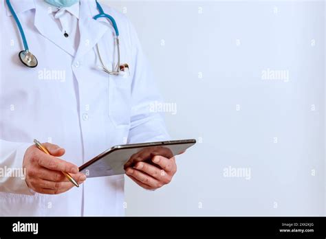 Healthcare Doctor Takes Notes In Digital Tablet Recording Patient
