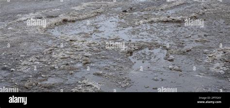 Damaged Asphalt Road With Potholes Caused By Freezing And Thawing