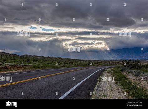 Picture Of A Lonely Road With Cloudy Sky And Impressive Sun Beams Stock Photo Alamy