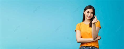 Smiling Asian Woman Shows Heart Sign Expresses Love Photo Background