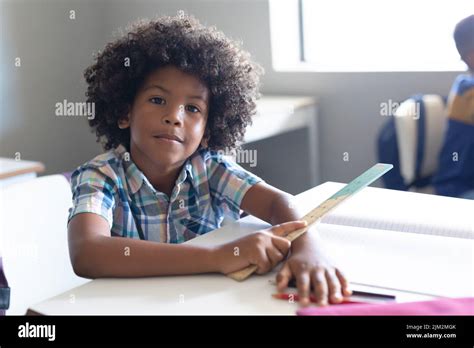 Portrait Of African American Elementary Schoolboy Holding Ruler While