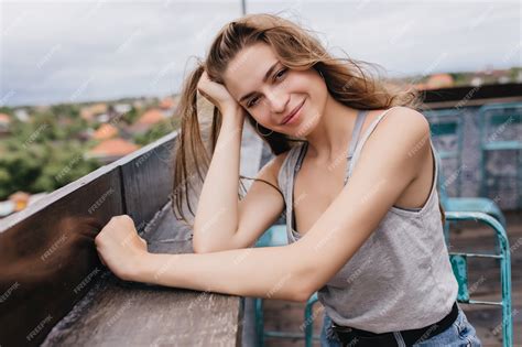 Free Photo Relaxed Pale Woman Sitting On Roof In Morning Outdoor