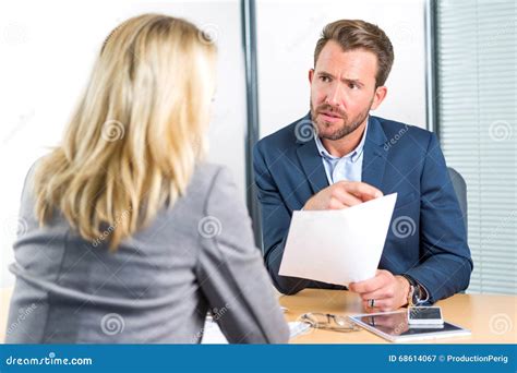 Young Attractive Employer Analysing Resume Of Woman Stock Image Image