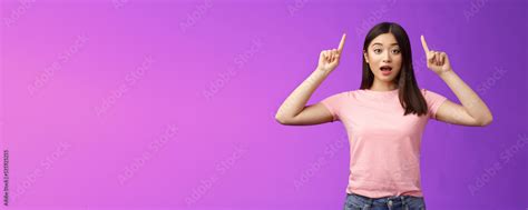 Excited Cute Surprised Asian Girl In Pink T Shirt Telling About Awesome