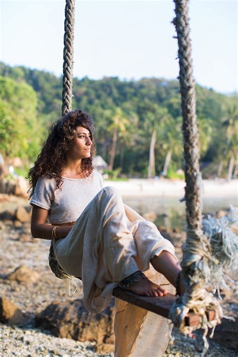 Woman Sitting On A Rope Swing By Stocksy Contributor Mosuno Stocksy