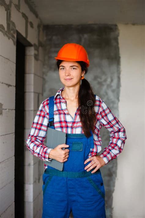 Construction Engineer Woman In Uniform And Protective Helmet Inspecting And Checking Repair