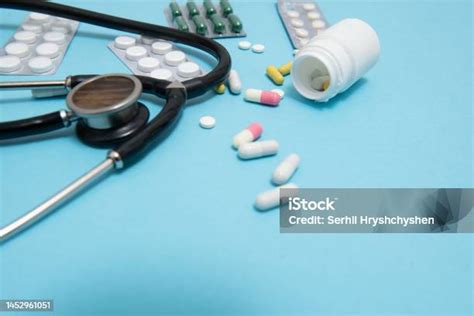 파란 테이블에 흩어져있는 흰색 알약입니다 의료 약국 및 건강 관리 개념 파란색 배경 흰색 알약 의료 Statoscope 상위 뷰