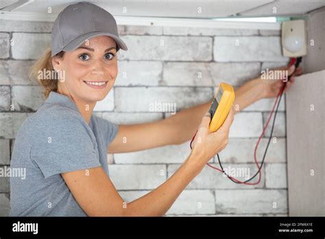 Female Electrician Using Multimeter On Circuit Breaker Cabinet Stock Photo Alamy