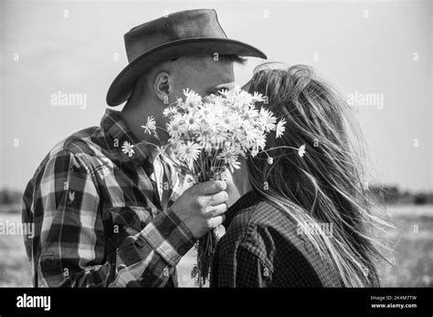 Couple In Love Of Man And Woman Kissing Behind Daisy Bouquet In