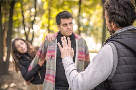 Two Aggressive Men In Quarrel And Woman Finger Pointing Stock Image