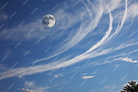 Premium Photo Moon Behind Wispy Cirrus Clouds
