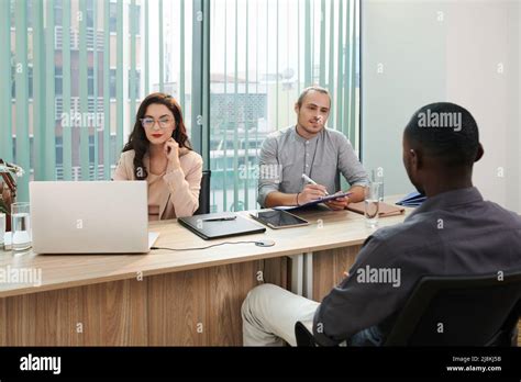 HR Manager Filling Form On Laptop When Employer Asking Applicant Some