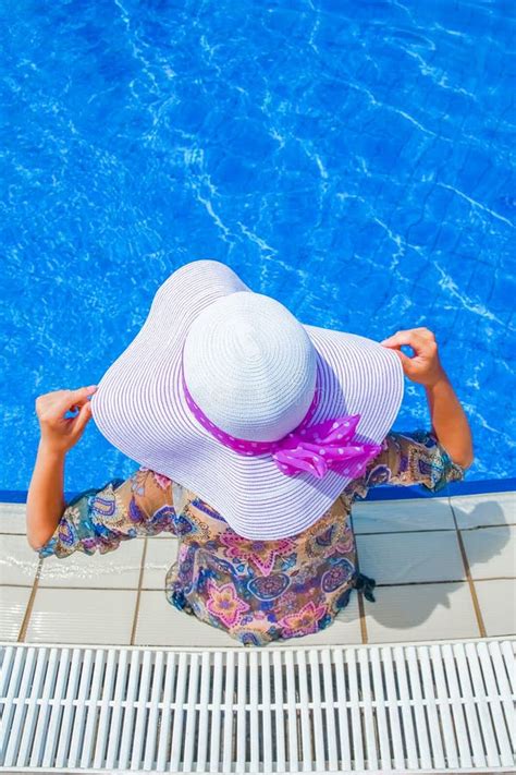 A Beautiful Legs Of A Girl Near A Swimming Pool On The Sea Background
