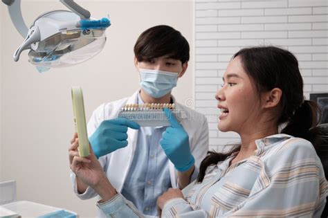 Male Dentist Explains Color Of Tooth Implant Whitening To A Female