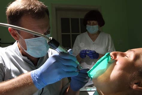 Dentist Treating A Patient`s Teeth With Dental Tools In Dental Clinic