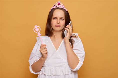 A Woman Dressed As A Princess Wearing A Pink Tiara And Holding A Pink