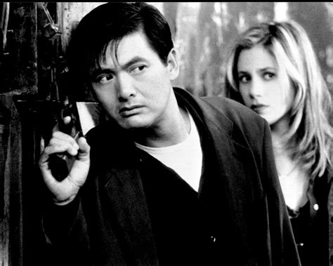 Chow Yun Fat And Mira Sorvino Against Wall In The Replacement Killers